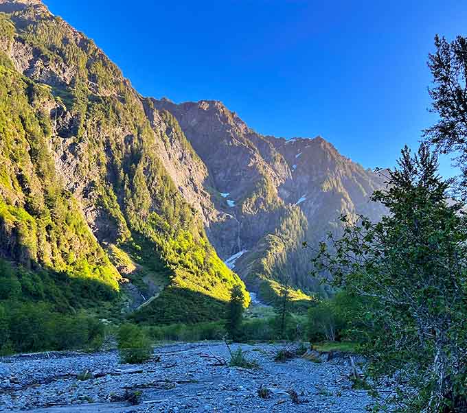 Morning light paints the valley walls gold, proving Mother Nature has better lighting skills than any Hollywood cinematographer.