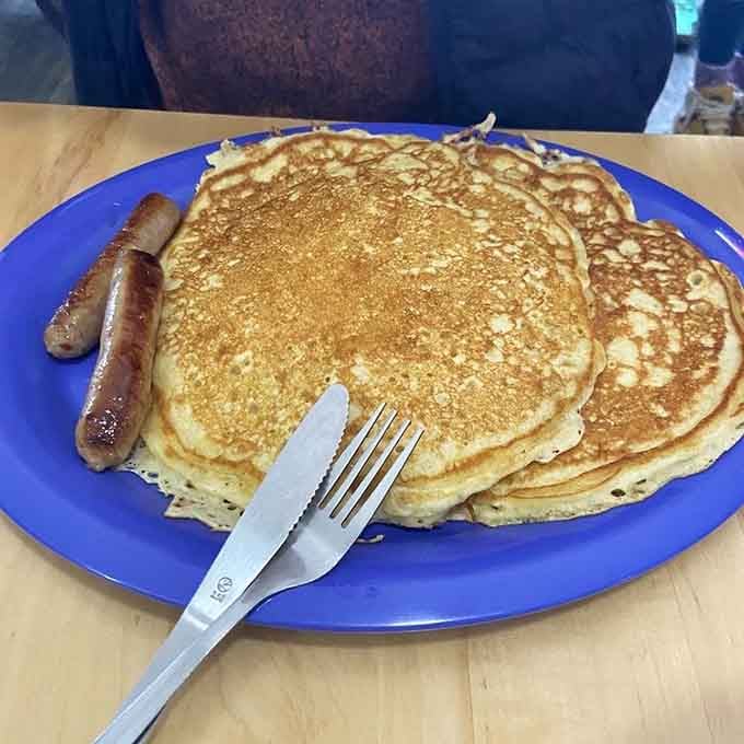 Pancakes that cover the plate like golden blankets of deliciousness, fluffy and ready for syrup.