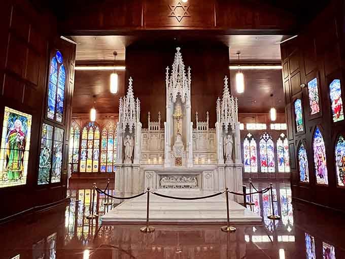 A grand marble altar rises at the far end, framed by stained glass on every side imaginable.