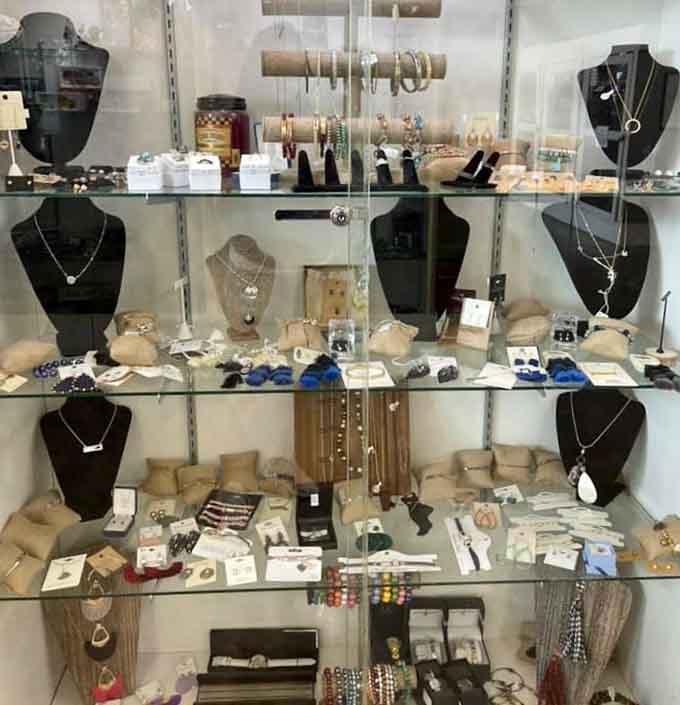 Jewelry displayed behind glass like tiny treasures in a museum, each piece ready for its next adventure.