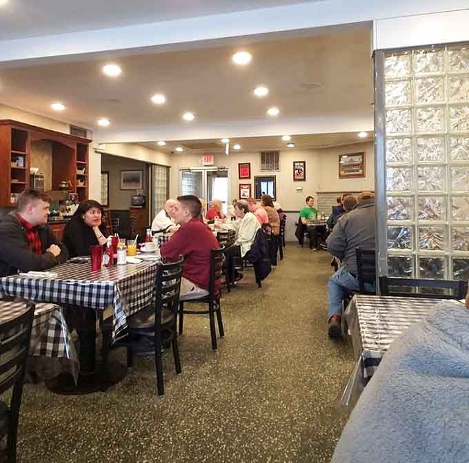 A full dining room buzzing with happy people and checkered tablecloths, this is what a well-loved neighborhood restaurant looks like.