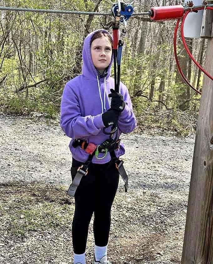 That focused expression says everything, gripping the zipline cable and deciding today is absolutely the day.