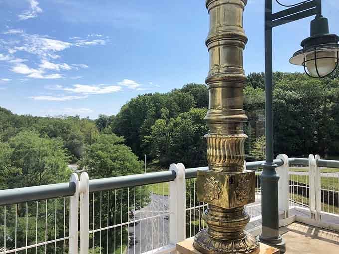 From this terrace, lush Ohio greenery stretches out below a gleaming brass pillar, proving sacred views need no passport.