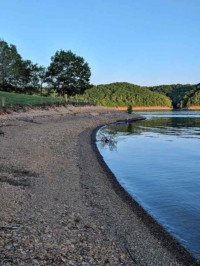 A quiet curve of shoreline at dusk, where the water barely moves and the whole world seems to exhale at once.