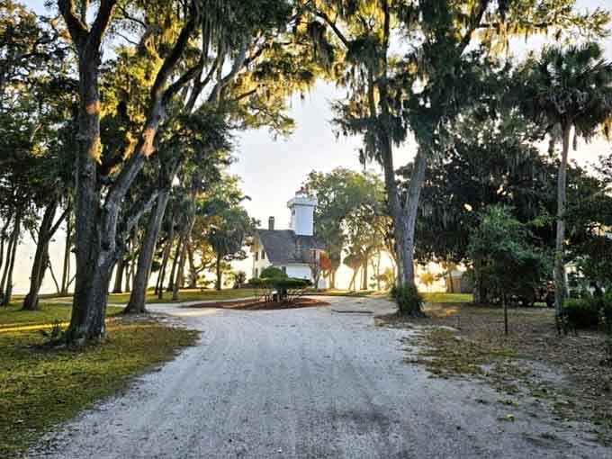 Spanish moss, golden light, and a gravel path leading straight to a lighthouse. This entrance earns its dramatic reputation completely.