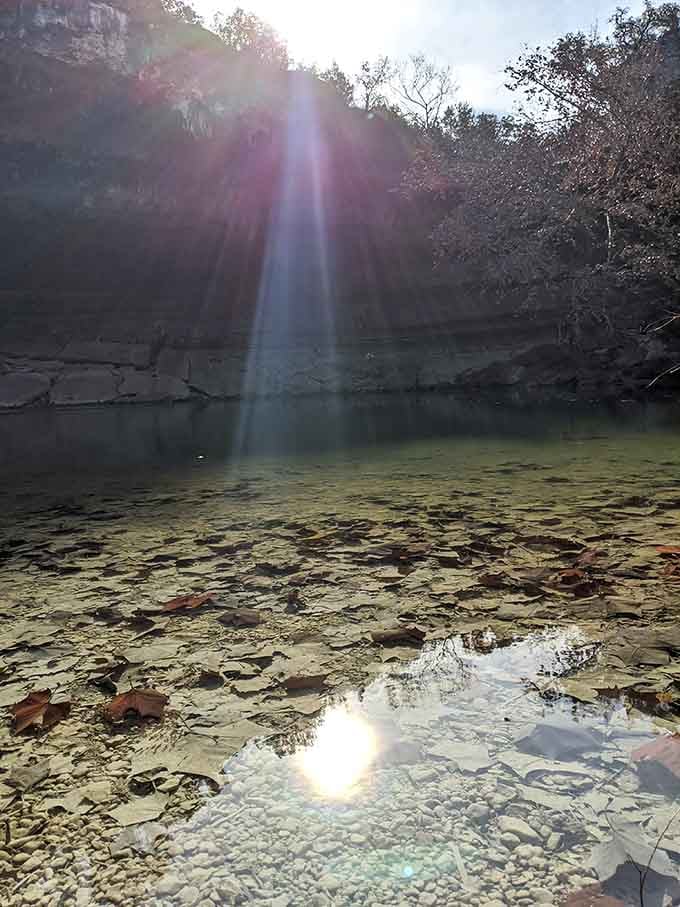 Sunbeams piercing through the grotto opening, creating that dramatic lighting Instagram dreams are made of.