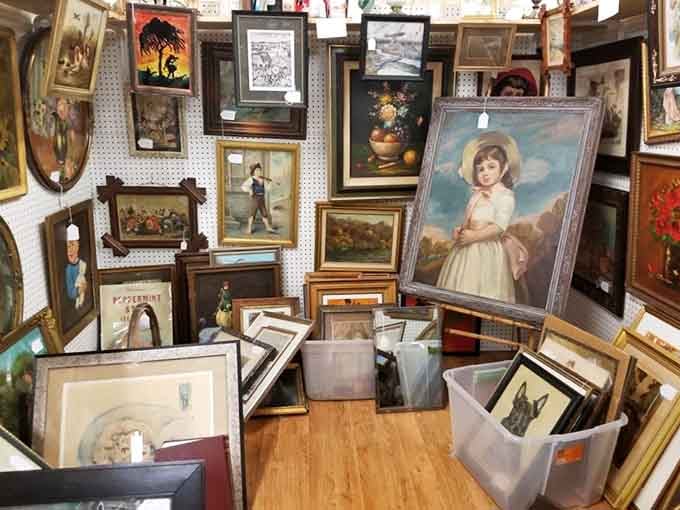 A wall of paintings stacked floor to ceiling, like a small art museum that forgot to charge admission.