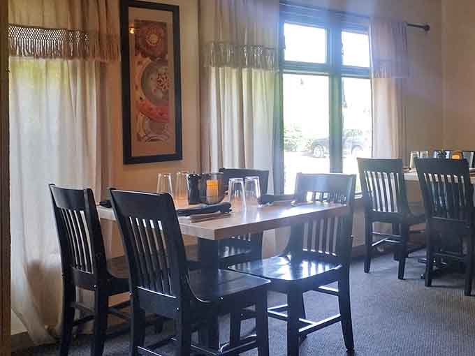 Linen curtains, dark wood chairs, and afternoon light pouring through tall windows. This table is ready, and so should you be.