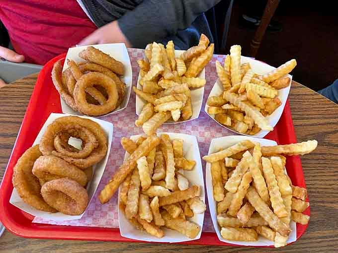 A full tray of onion rings and crinkle fries that could make even the most disciplined person reconsider everything.