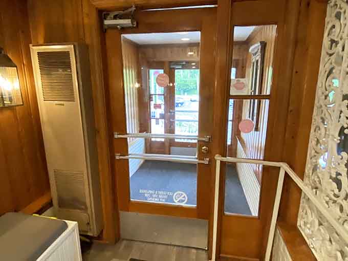 The warm wood-paneled entryway is your first hint that something genuinely special is waiting just beyond that door.