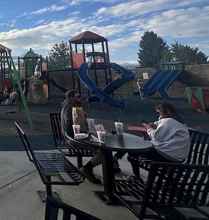 Shaded seating lets parents refuel while keeping watchful eyes on their endlessly energetic offspring at play nearby.