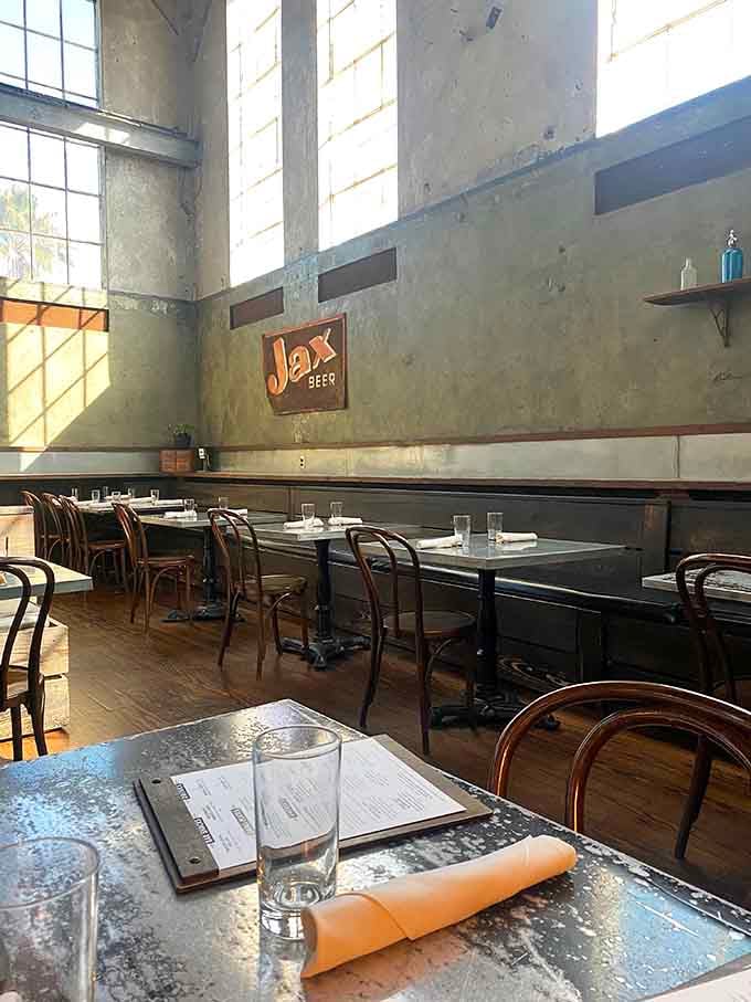 Tall windows, bentwood chairs, and a vintage Jax Beer sign on the wall, history and lunch coexisting beautifully together.