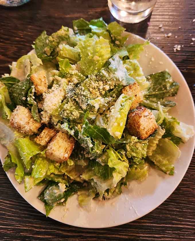 Crisp romaine, golden croutons, and a generous snowfall of parmigiano. This Caesar salad means serious business.