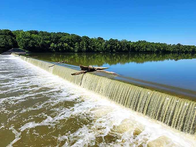 Water spilling over the dam like it has somewhere important to be and absolutely no regrets.