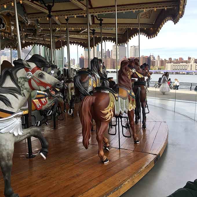 Rows of restored wooden horses, the skyline beyond the glass. New York never looked this timeless.