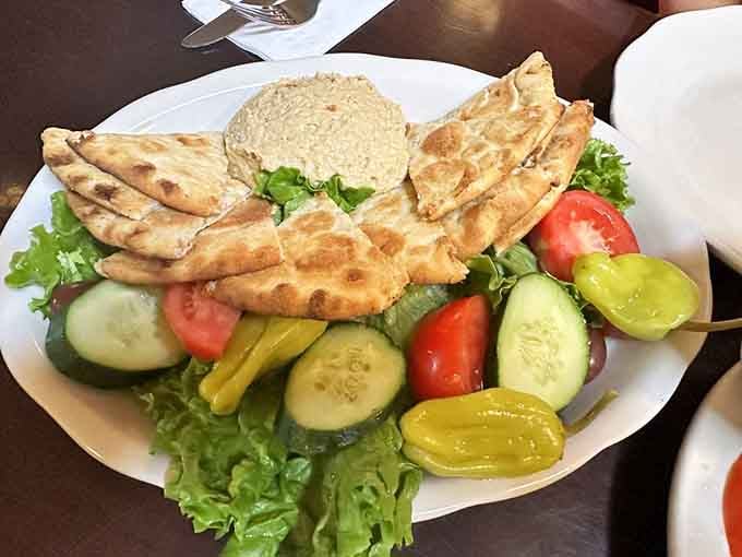 The Homemade Hummus Platter with warm pita and fresh vegetables. A starter that earns its place on the table.