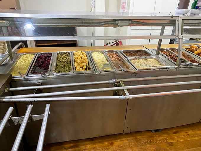 A long, loaded food bar full of Southern sides. Choosing just one vegetable here is genuinely the hardest part of lunch.