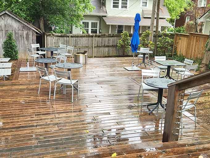 Rain-kissed wooden deck seating proves that even wet weather can't diminish the charm of this outdoor retreat space.