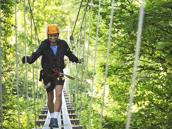 One foot in front of the other, suspended above the trees, grinning like you own the place.