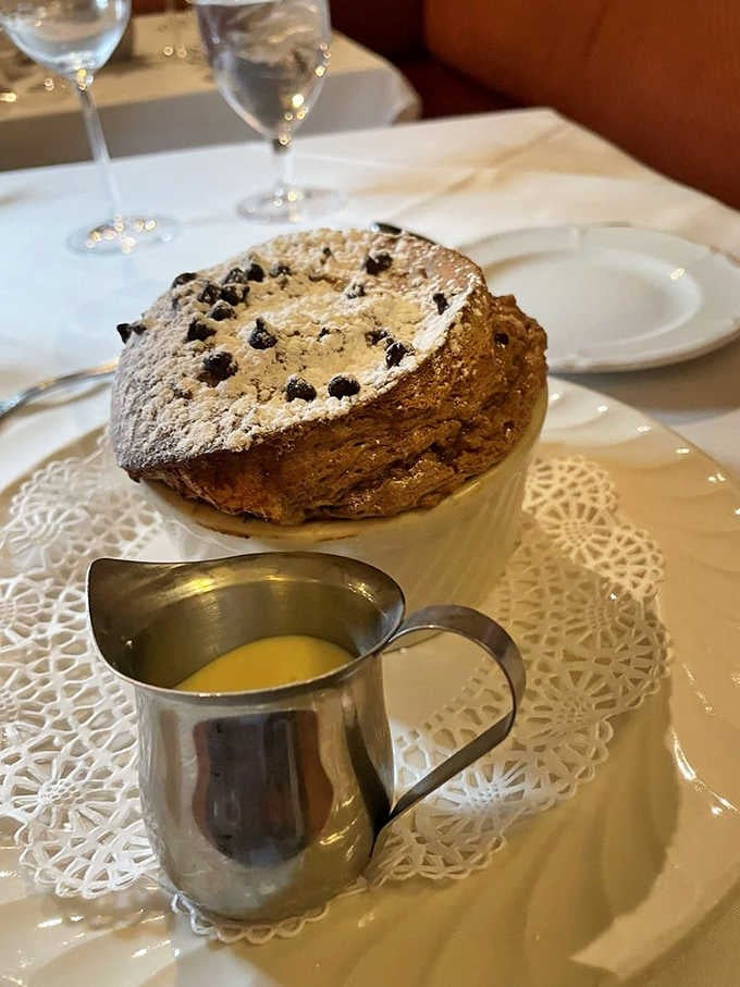 A chocolate souffl&eacute; dusted with powdered sugar, served with cr&egrave;me anglaise. This is the grand finale that earns a standing ovation.