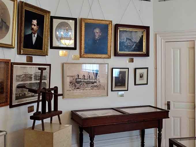 Portraits, locomotive drawings, and artifacts covering the walls. This room holds more Passaic County history than most textbooks do.