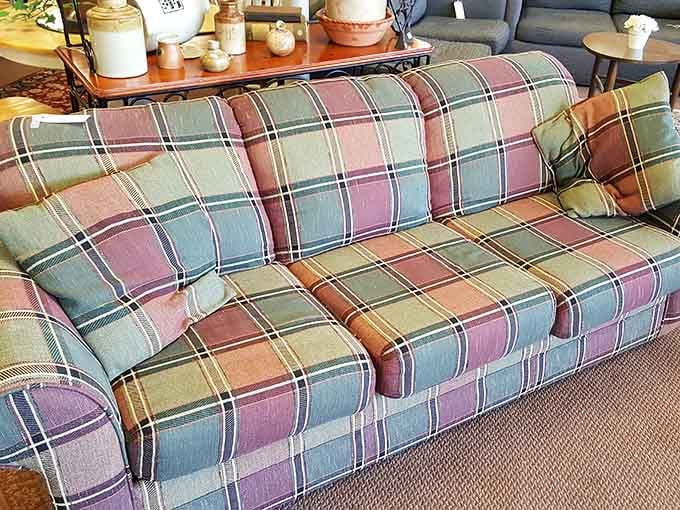 That plaid sofa has more personality than most furniture you'd find at full retail price, and it's ready for its second act.