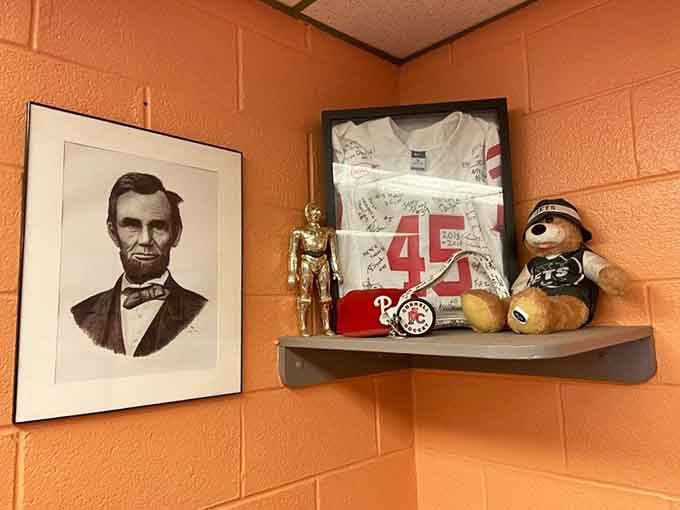 Abraham Lincoln watching over a shelf of sports memorabilia and collectibles, because why not add a little history to breakfast.