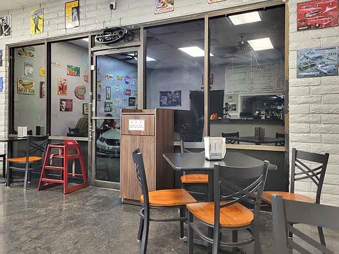 Vintage tin signs covering every inch of the wall. This dining room tells you exactly where its heart is.