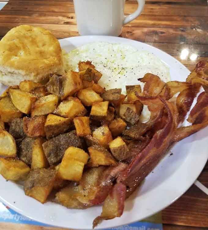 Hash browns, bacon, eggs, and a biscuit create the breakfast plate that makes alarm clocks worth setting.