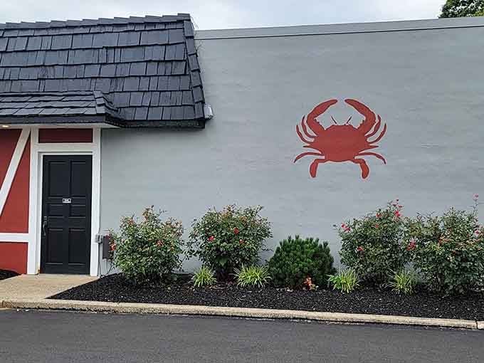 A bold red crab painted on a gray wall, a simple but unmistakable promise of what's waiting inside.