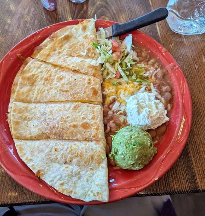 Quesadilla wedges served with all the fixings, proving simple done right beats complicated done wrong every time.