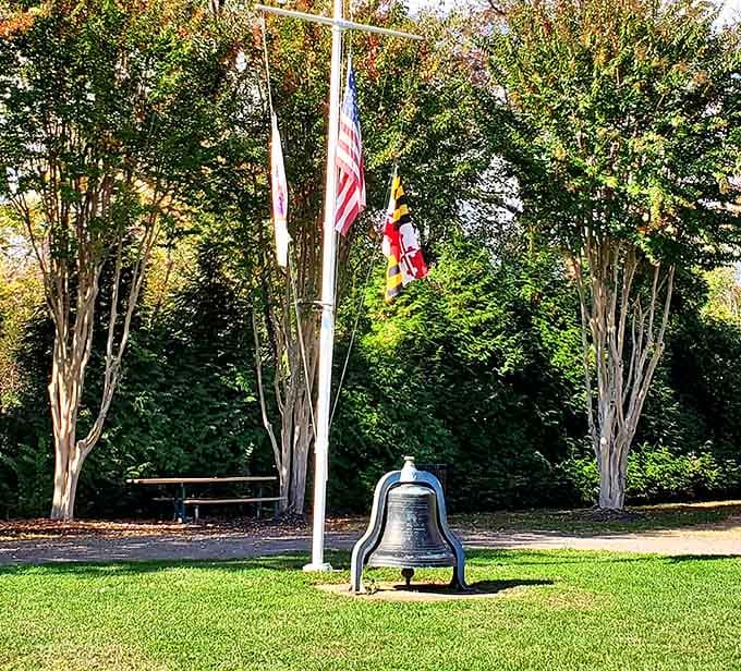 The ceremonial flagpole and historic ship bell stand quietly, honoring the Bay's long and storied past.