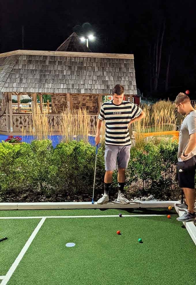 Mini golf under the lights hits differently, especially when the gazebo glows like a tiny Swiss chalet at midnight.