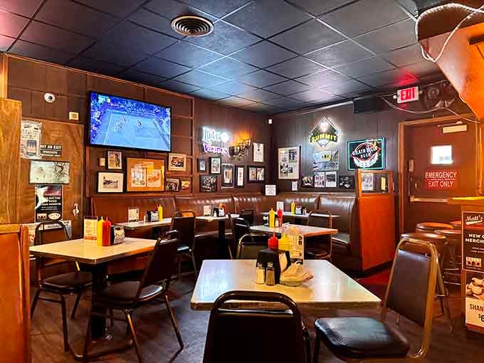 Dark wood paneling, framed photos covering every inch of wall space, and a TV in the corner, this dining room feels like your favorite uncle's basement.