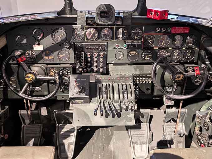 A WWII-era cockpit up close, rows of dials and levers that make your car's dashboard look embarrassingly simple.