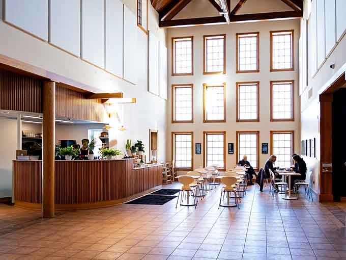 Tall windows, warm wood, and a welcoming cafe counter. Rest your feet here before heading back out to see more.