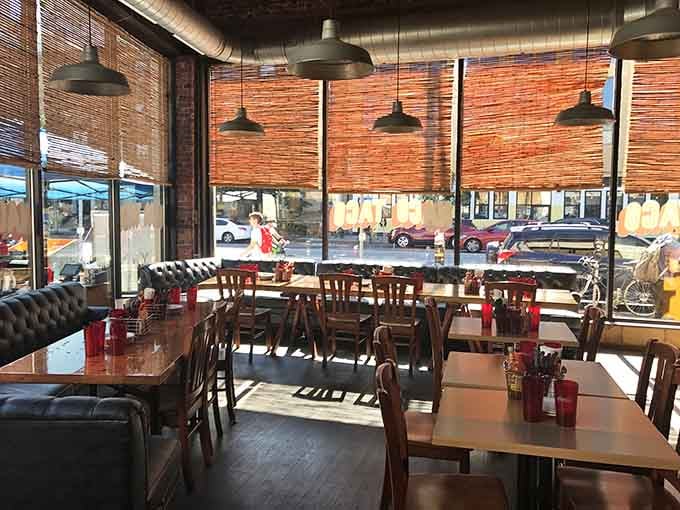 Warm wood tables, bamboo shades filtering afternoon light, leather booths along the window. Comfortable in the best possible way.