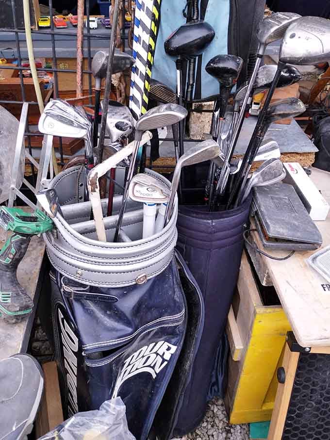 Two full golf bags packed with clubs, waiting patiently for someone to give them a second round on the course.