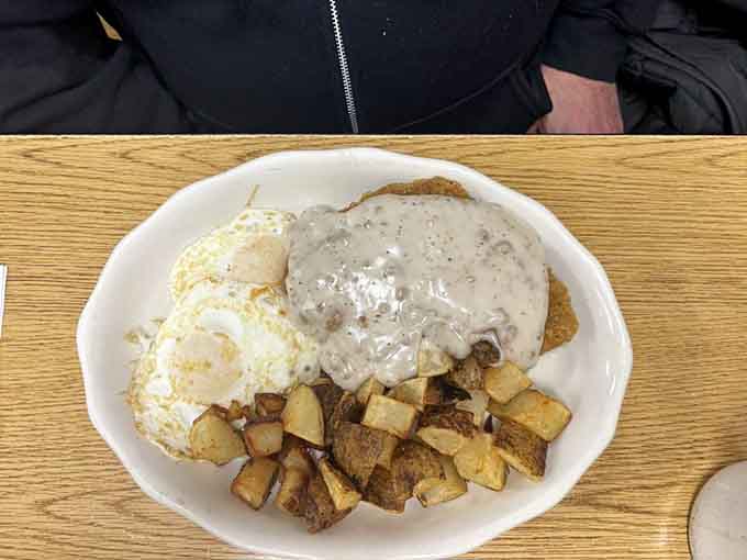 Chicken fried steak smothered in country gravy, flanked by eggs and homefries. Comfort food that wraps around you like a warm blanket.