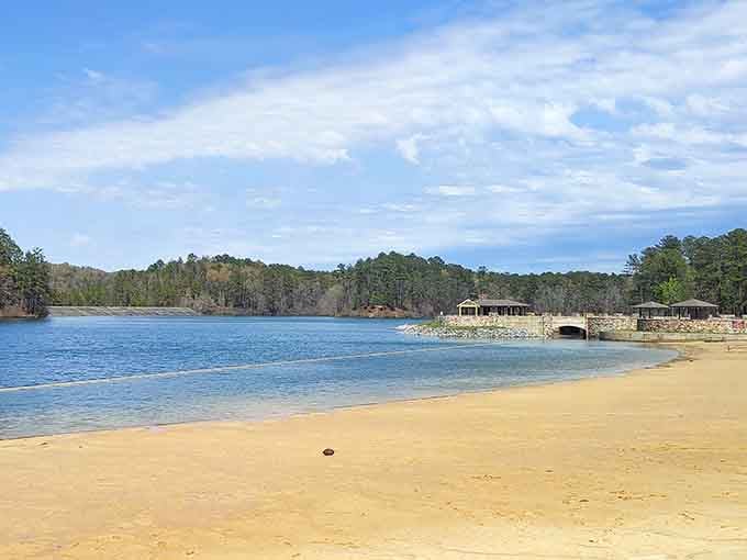 That golden shoreline curving toward stone pavilions is the kind of view that stops you mid-sentence.