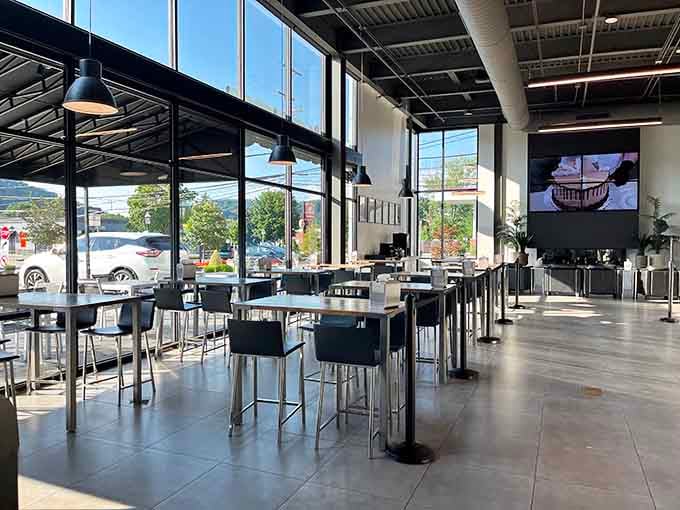 Tall windows, clean tables, and a video wall showing cake being decorated. Honestly, better programming than most cable channels.