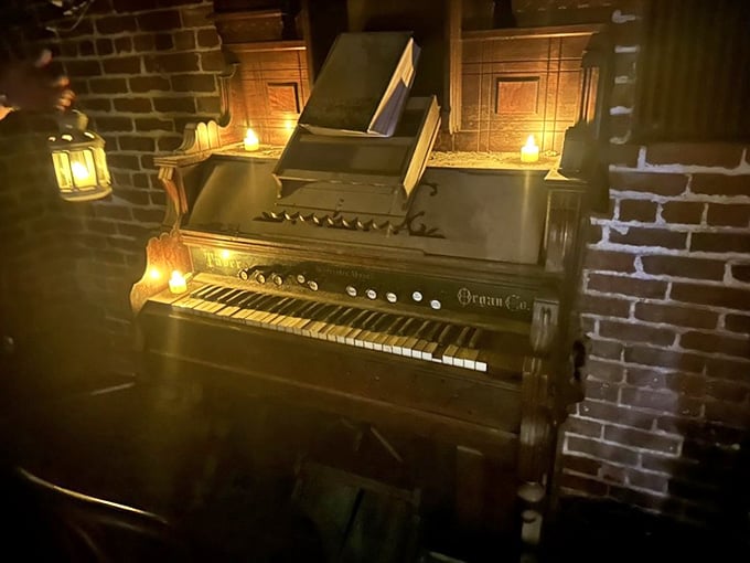 Candlelit and quietly dramatic, this antique organ sitting against the brick wall belongs in a gothic novel. Or a very good dream.