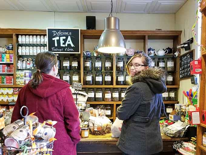 Two customers deep in the tea wall, making very important decisions. Take your time. No rush.