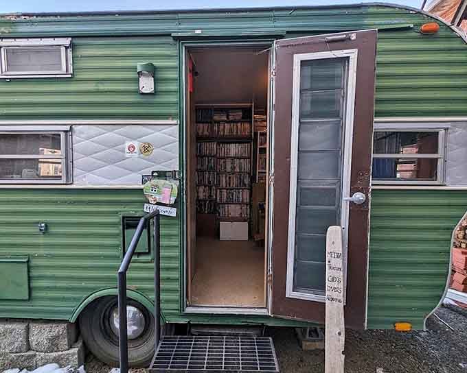 A vintage green trailer packed wall-to-wall with DVDs and media, proof that the best surprises come in the most unexpected packages.