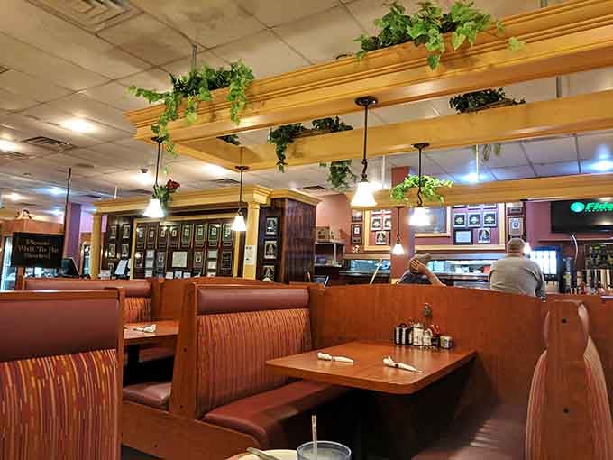Trailing ivy, warm pendant lights, and rows of inviting booths, this dining room has "stay a little longer" written all over it.