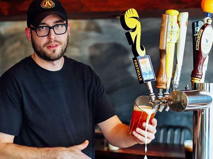 A focused bartender pulling a fresh draft, the kind of pour that deserves your full, undivided attention.
