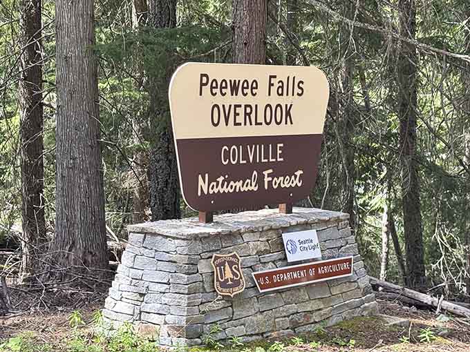 The Colville National Forest sign marking Peewee Falls Overlook is modest, much like the waterfall it points toward is not.