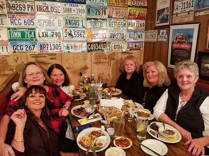 License plates from across America line the walls, proof that word travels fast when the food is this good.