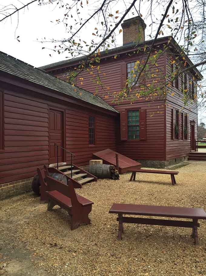 Wooden benches, gravel paths, and that unmistakable red exterior reminding you that history doesn't need to shout to get your attention.