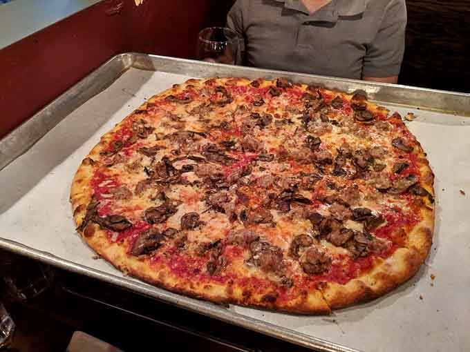 Sausage and mushrooms blanketing a gorgeous red pie. This is the kind of pizza that makes you cancel your plans.
